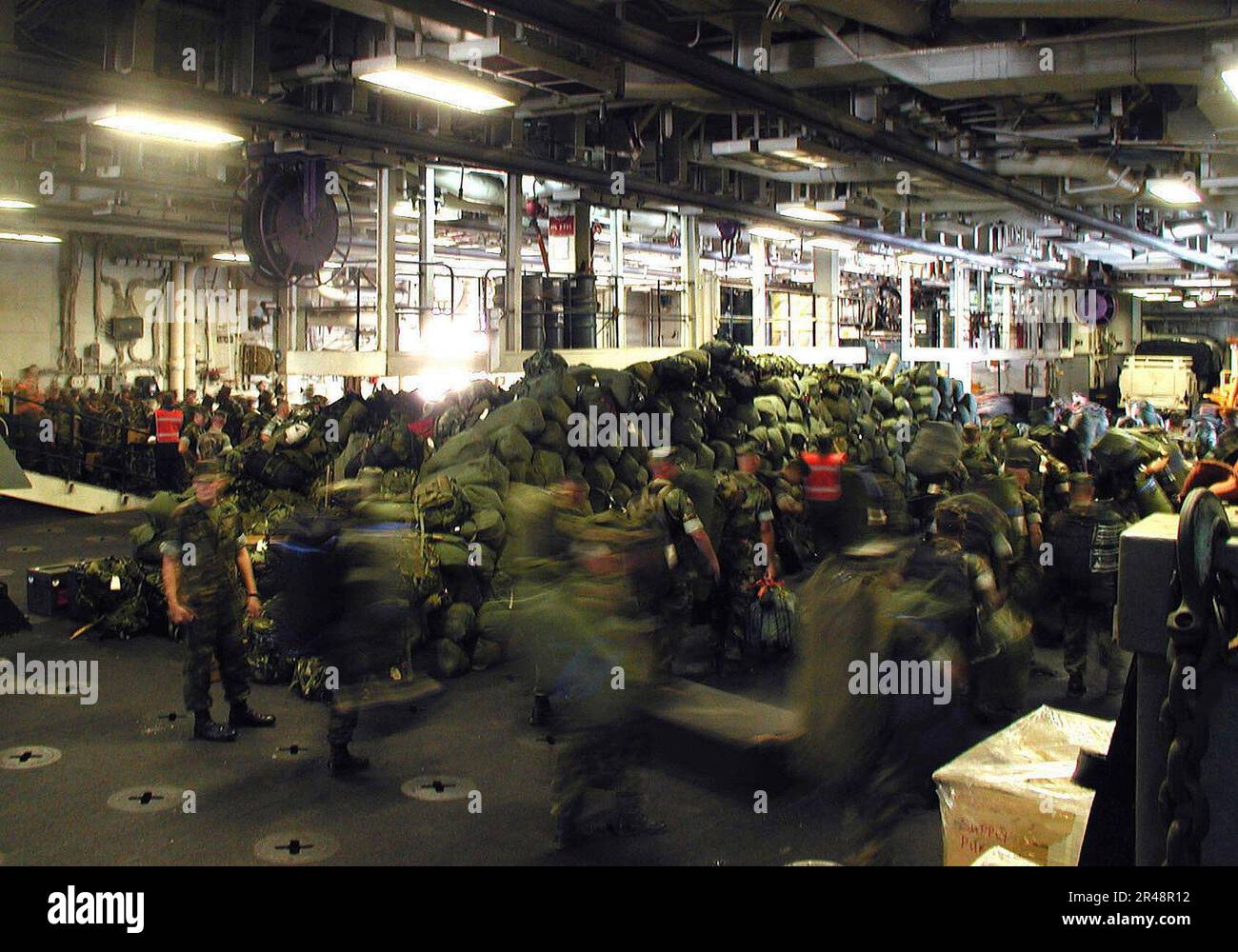 US Navy Marines load their gear in the welldeck aboard the Wasp-class ...