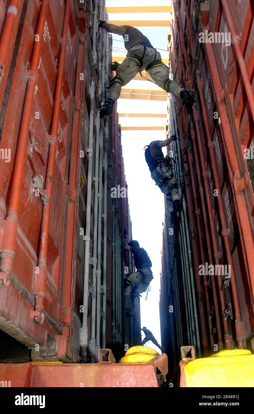 US Navy Sailors assigned to USS Monterey inspect empty cargo containers ...