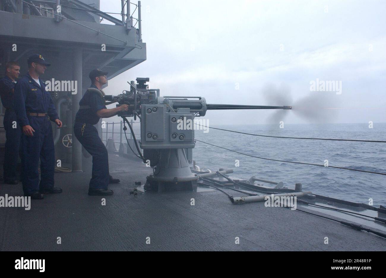 US Navy firing the 25mm gun aboard USS Bunker Hill Stock Photo - Alamy