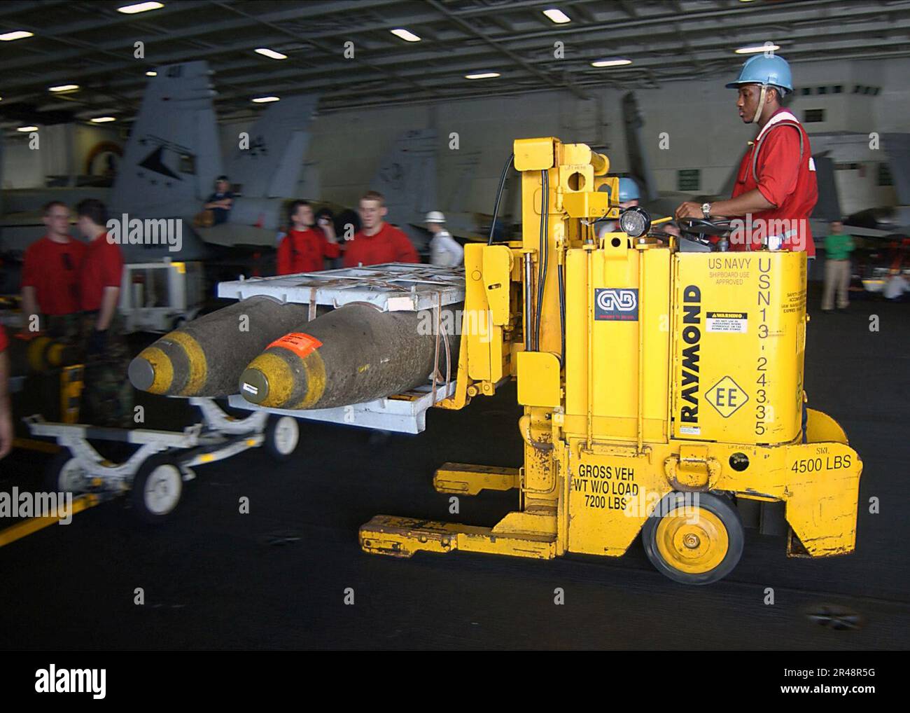 US Navy moving ordnance in the hangar bay Stock Photo - Alamy
