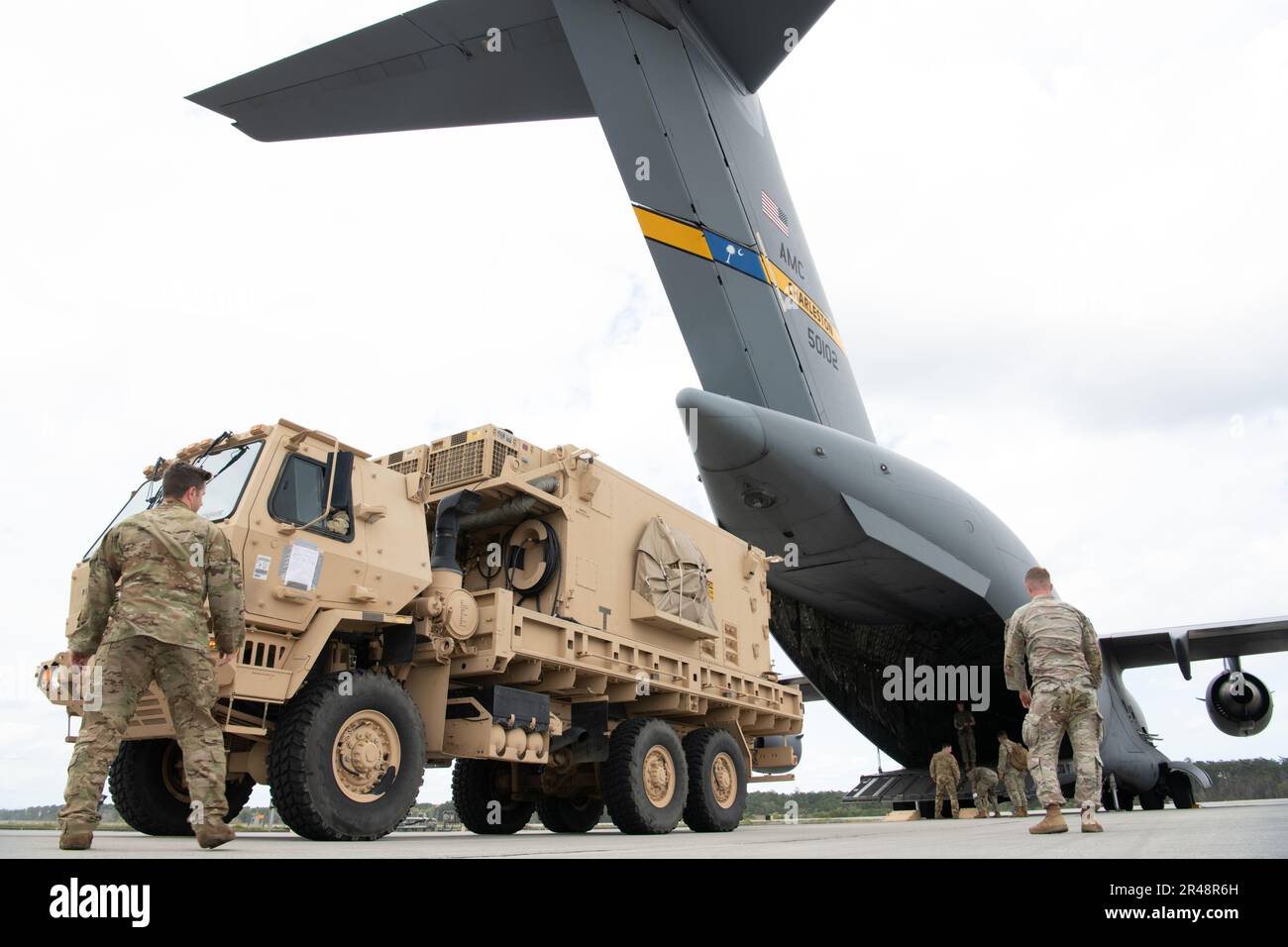 U.S. Army soldiers and Air Force airmen load an engagement control ...