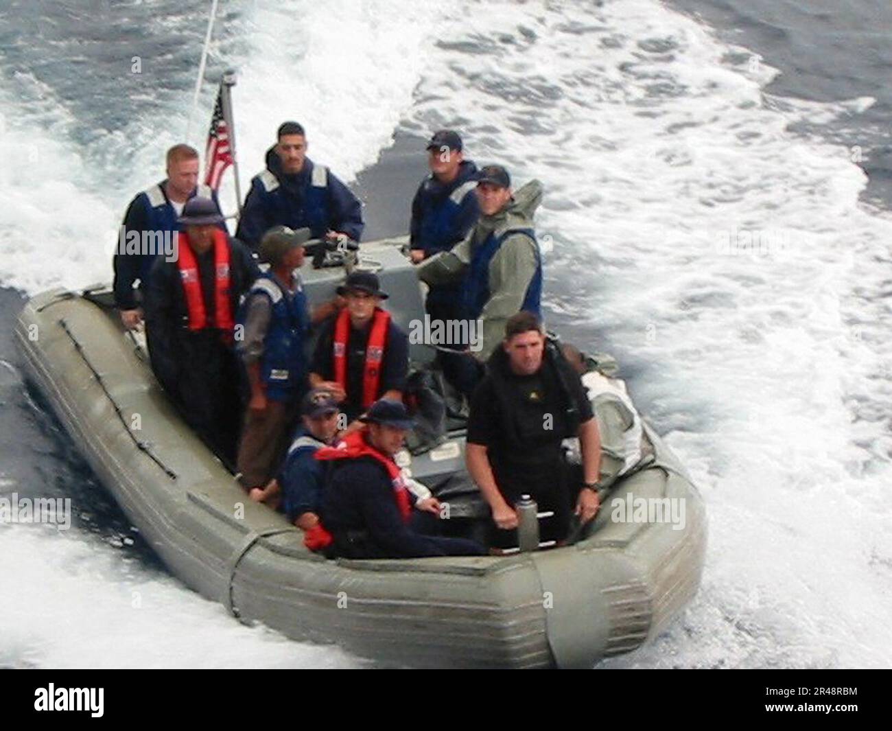 US Navy RHIB boat deployes from FFG 41 for rescue at sea Stock Photo ...