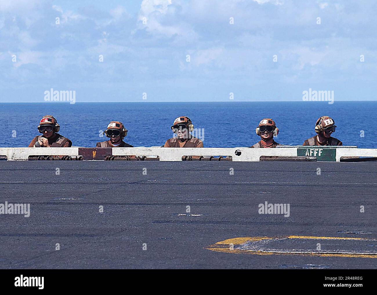 US Navy Sailors watch flight operations from the ship's catwalk Stock ...
