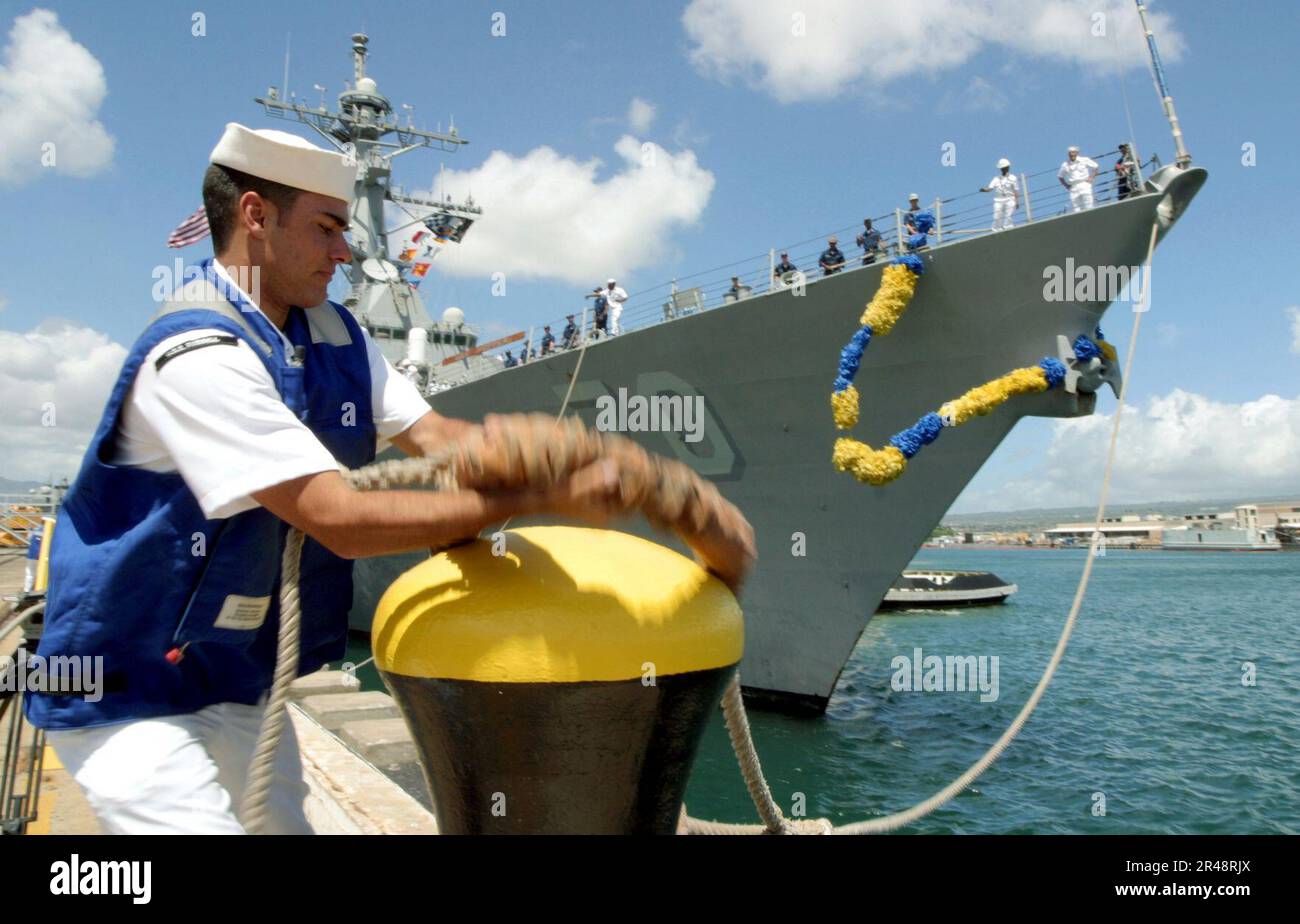 US Navy Lineman places line one over a bollard to begin the mooring ...