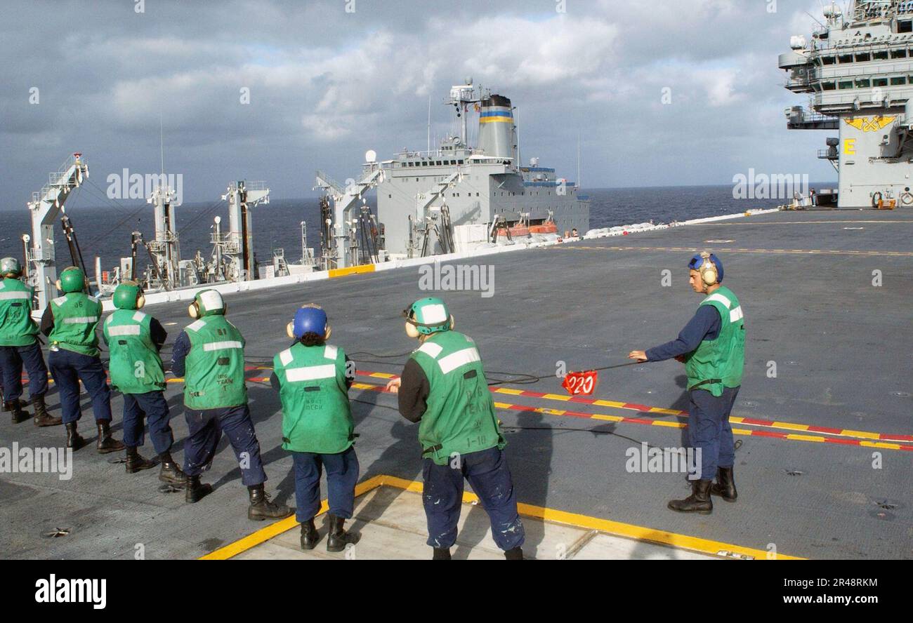 US Navy Line handlers control the messenger line aboard USS Carl Vinson ...