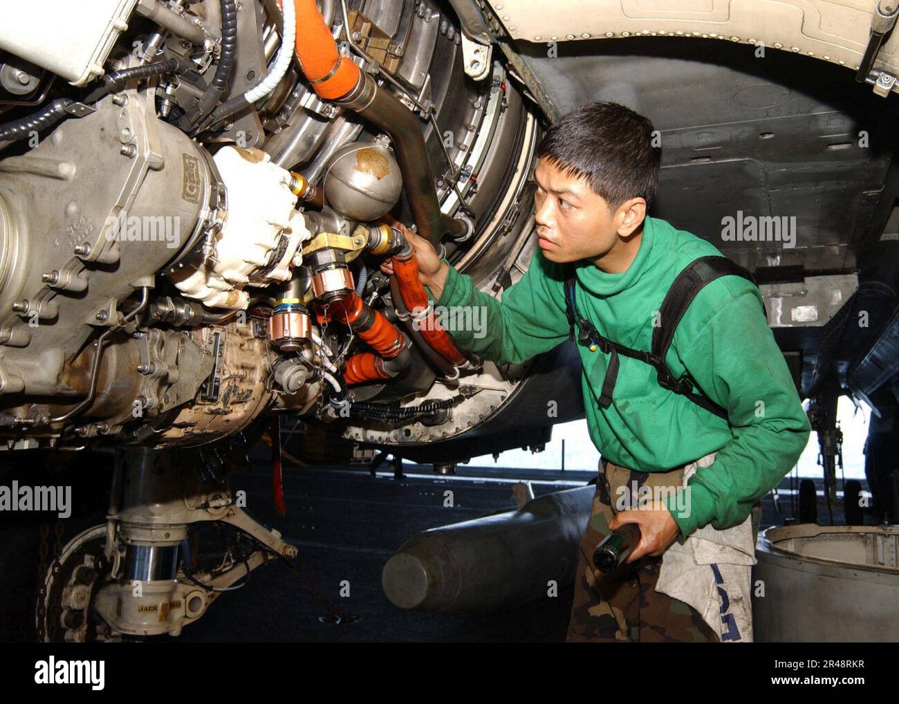 US Navy A Sailor installs the engine on an F-14D ''Tomcat.'' Stock ...