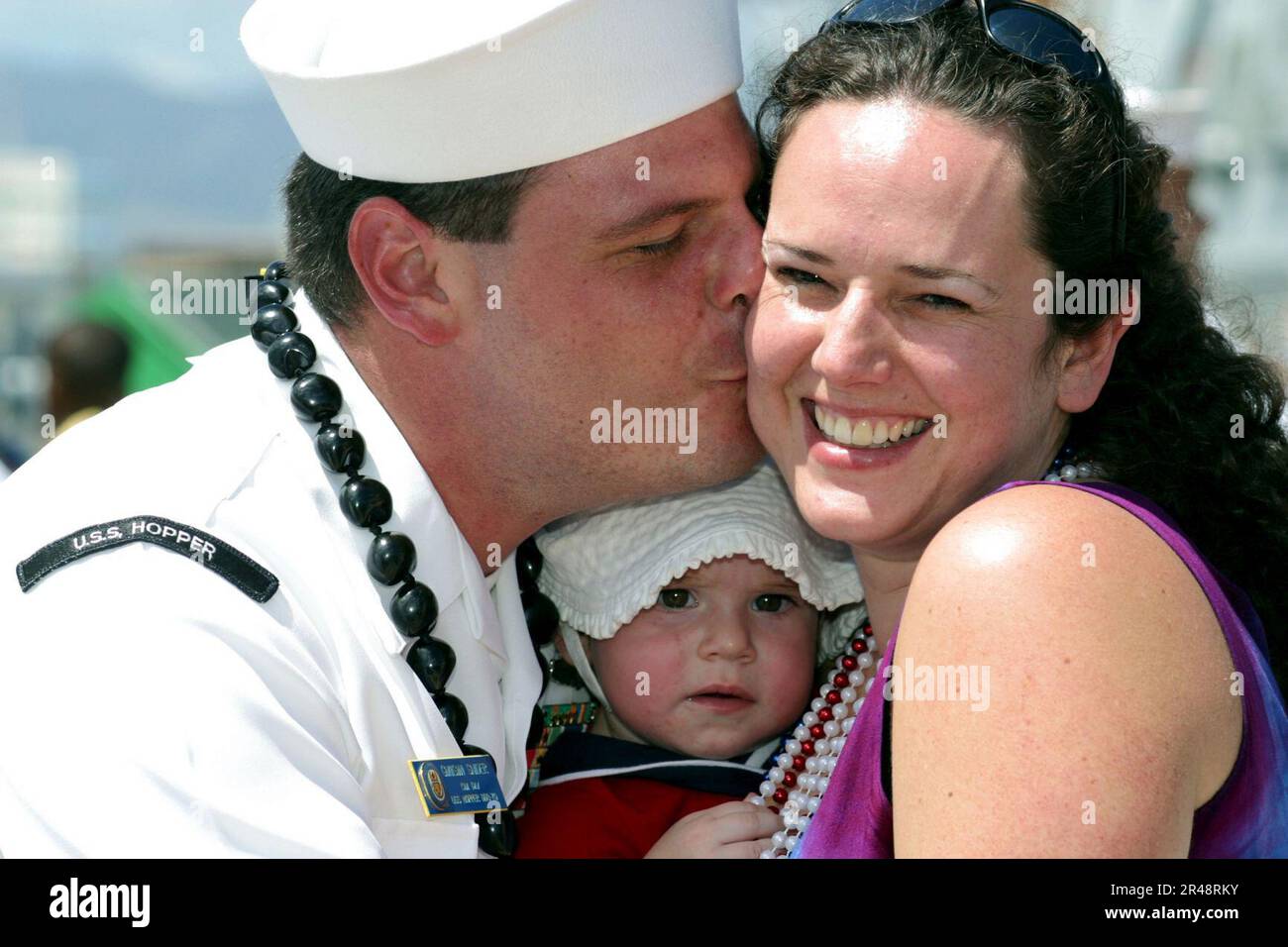 US Navy Gunner's Mate greets his wife and daughter after returning to ...