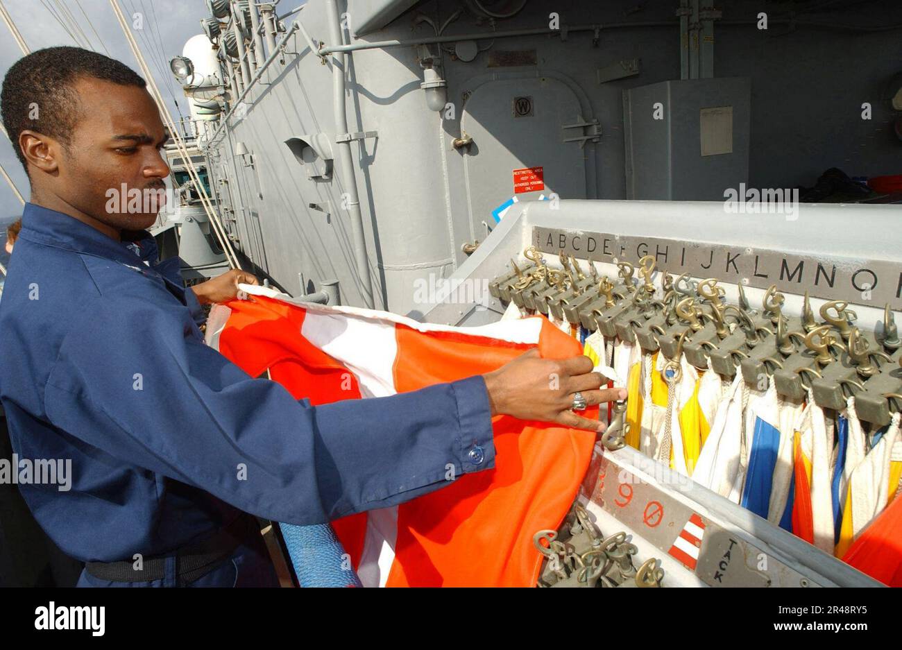 US Navy Sailor prepares signal flags for at sea operations Stock Photo ...