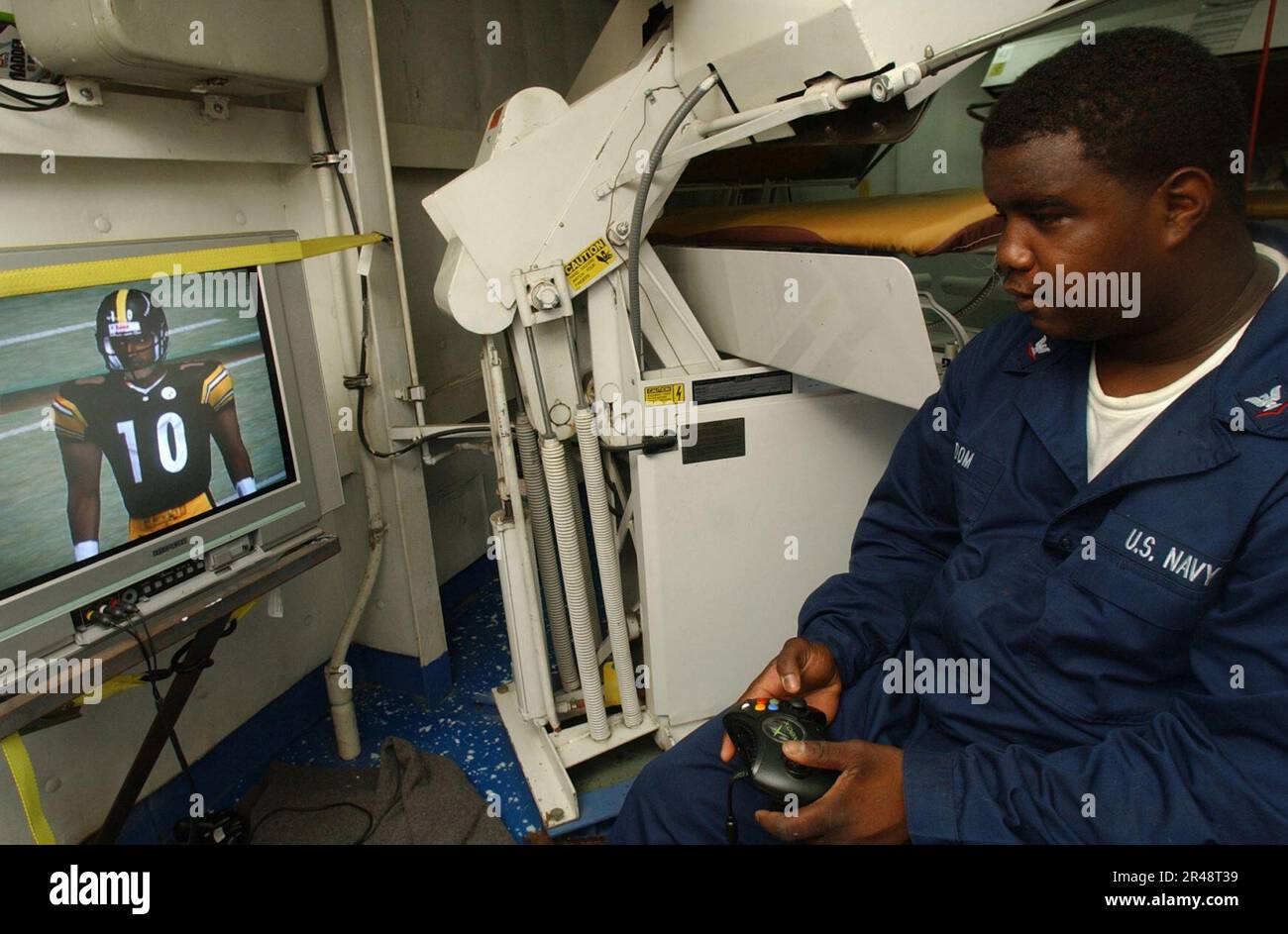US Navy Ships Serviceman Third Class Sheikeil Odom relaxes after duty ...