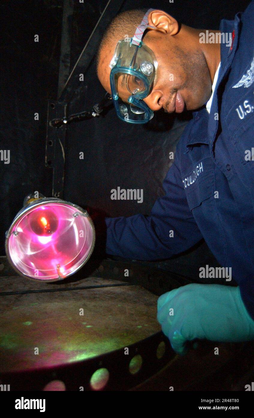 US Navy Dye-penetrant inspection while conducting maintenance on a P-3 ...