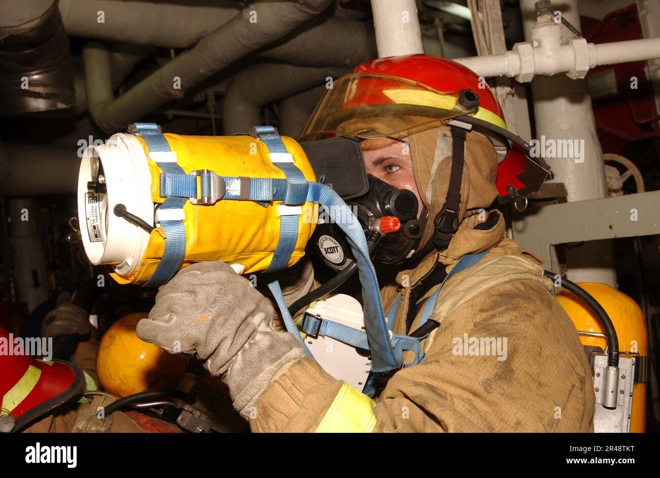 US Navy Damage Controlman during a General Quarters (GQ) drill, checks ...