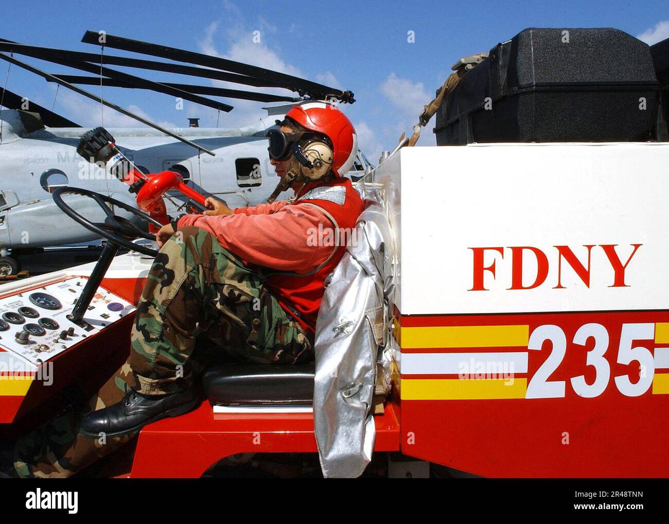 US Navy Crash and salvage team member stands watch during flight ...