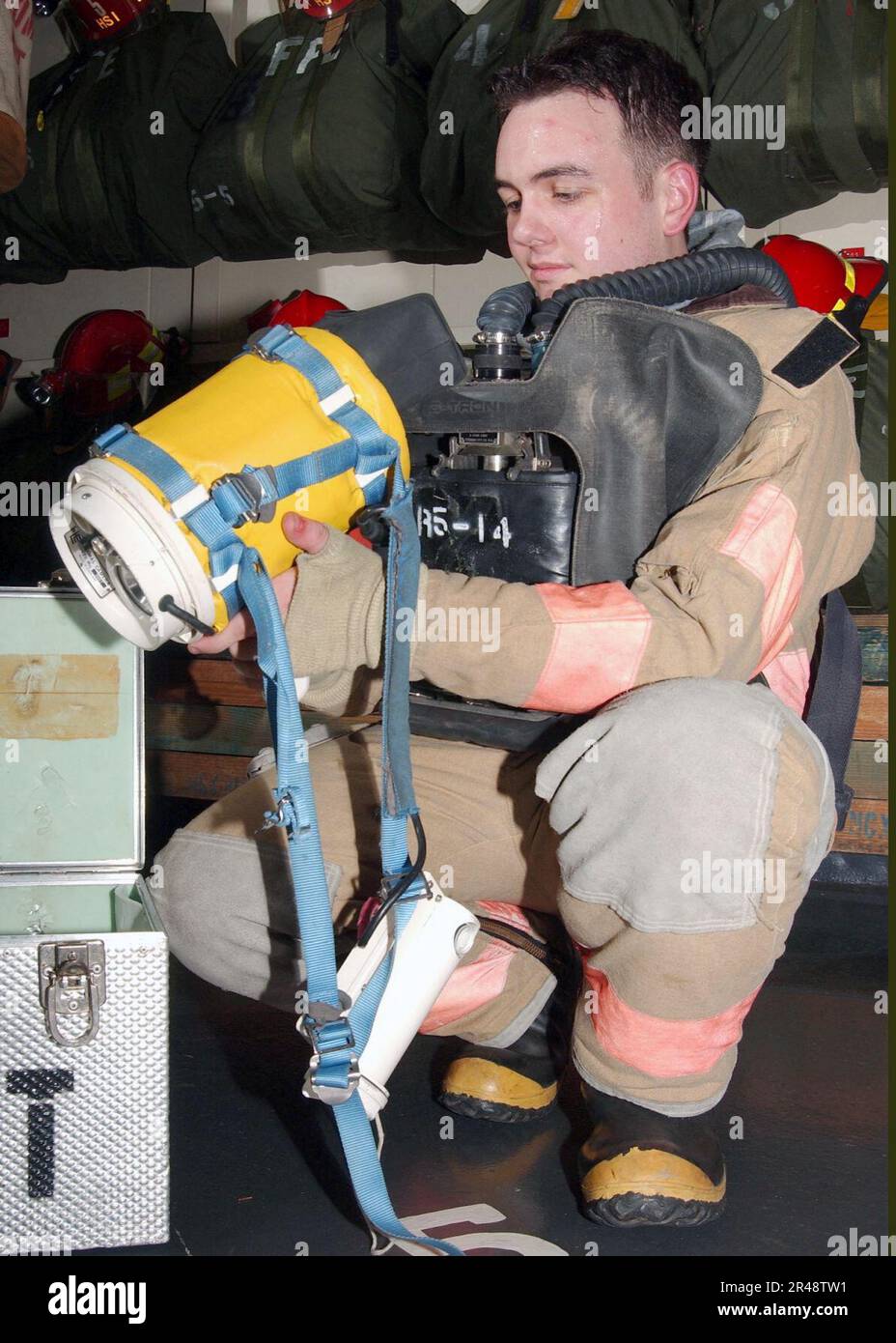 US Navy Damage Controlman inspects the Naval Firefighting Thermal ...