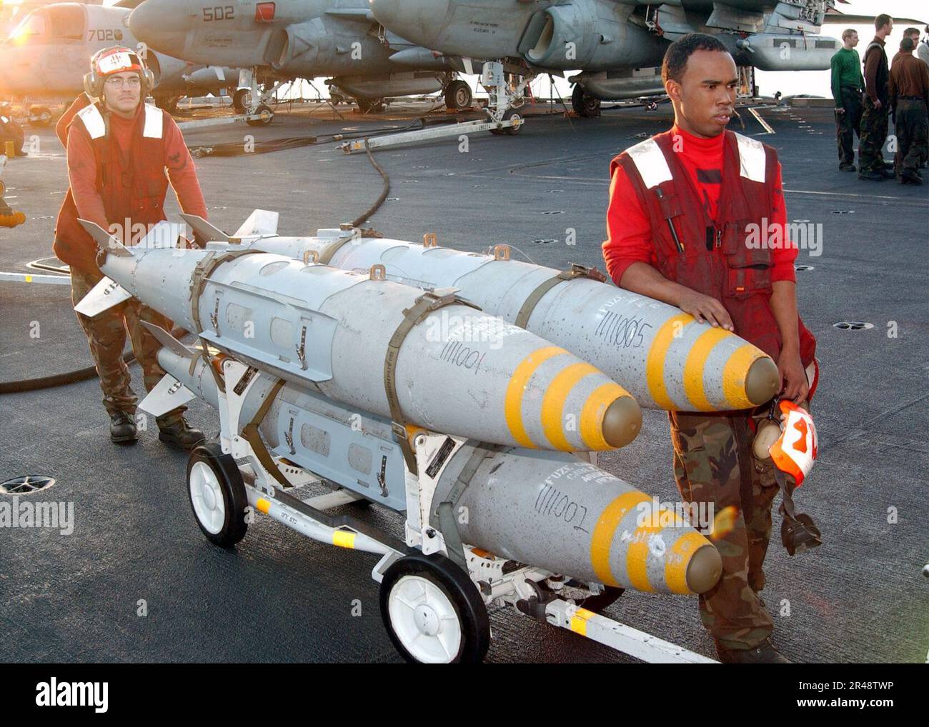 US Navy Aviation Ordnancemen prepare to move three Guided Bomb Units ...