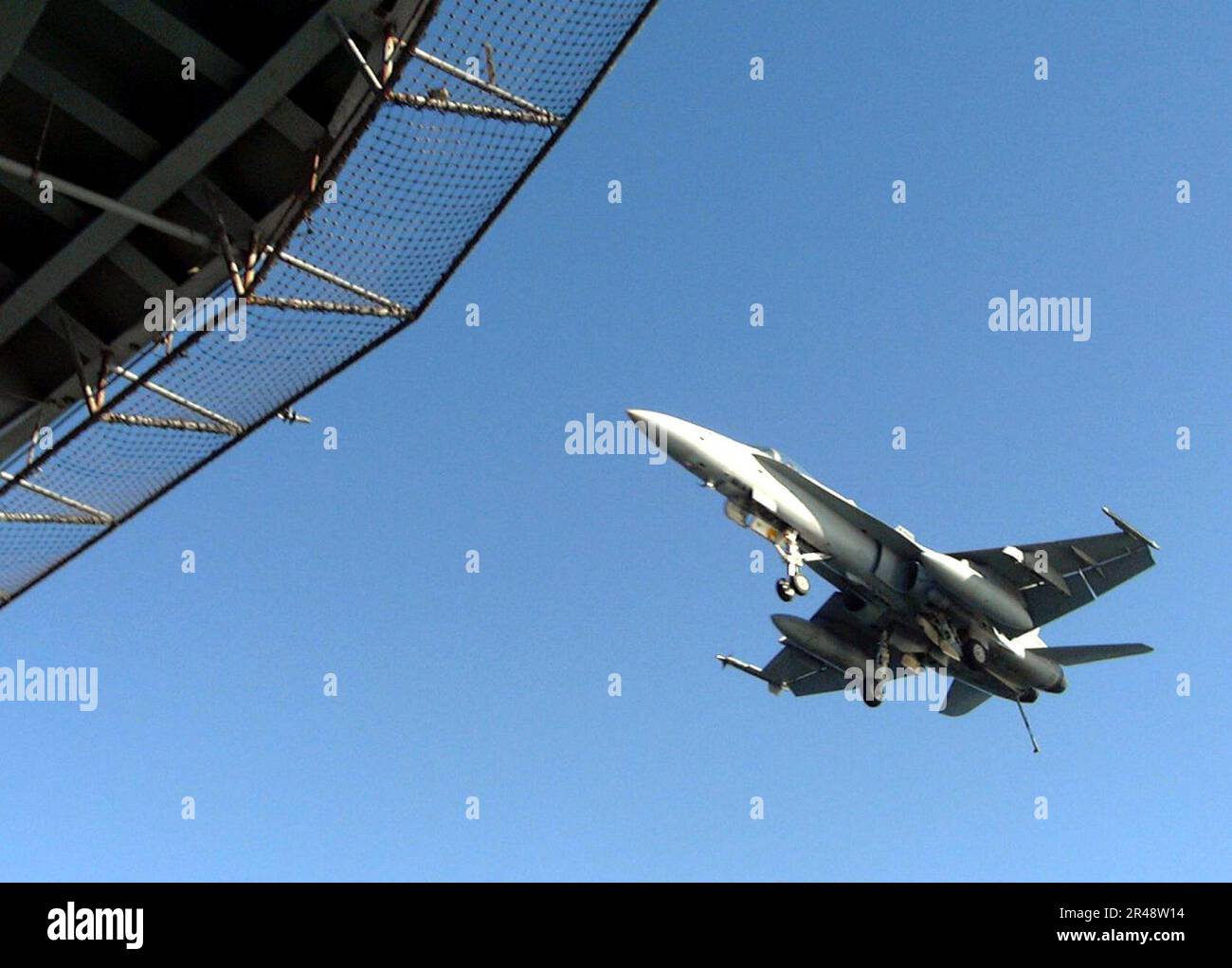 US Navy An F-A-18C Hornet approaches the ship's flight deck with its ...