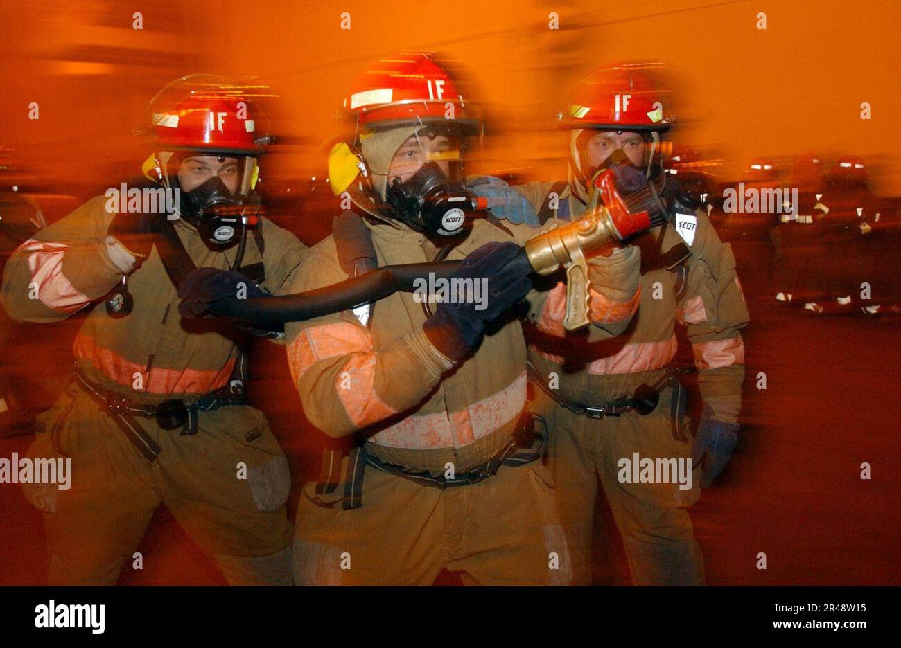 US Navy Firefighting team conducts training in the ship's hangar bay ...