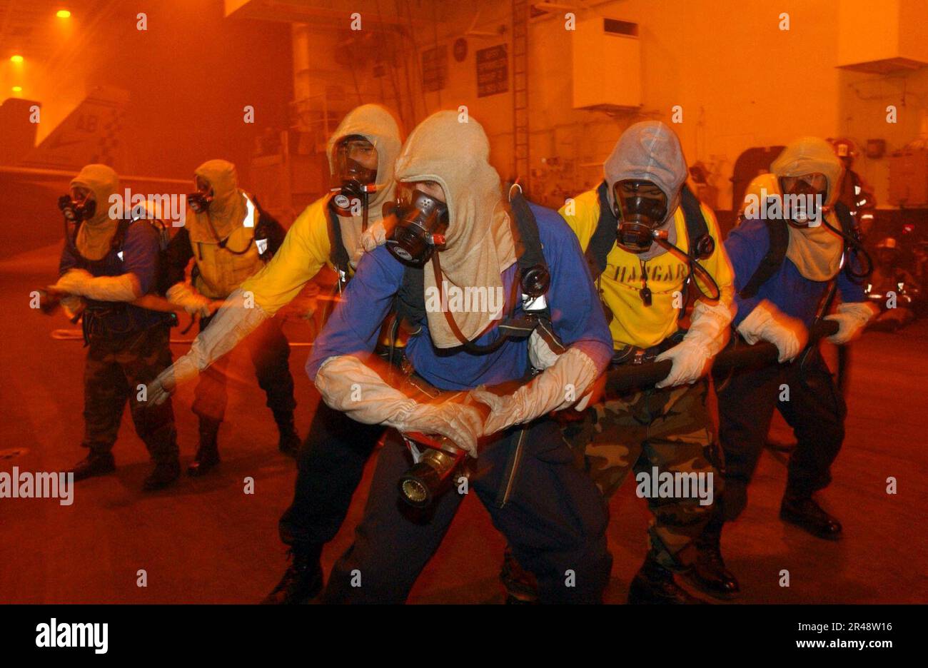 US Navy A firefighting team conducts a training drill in the ship's ...