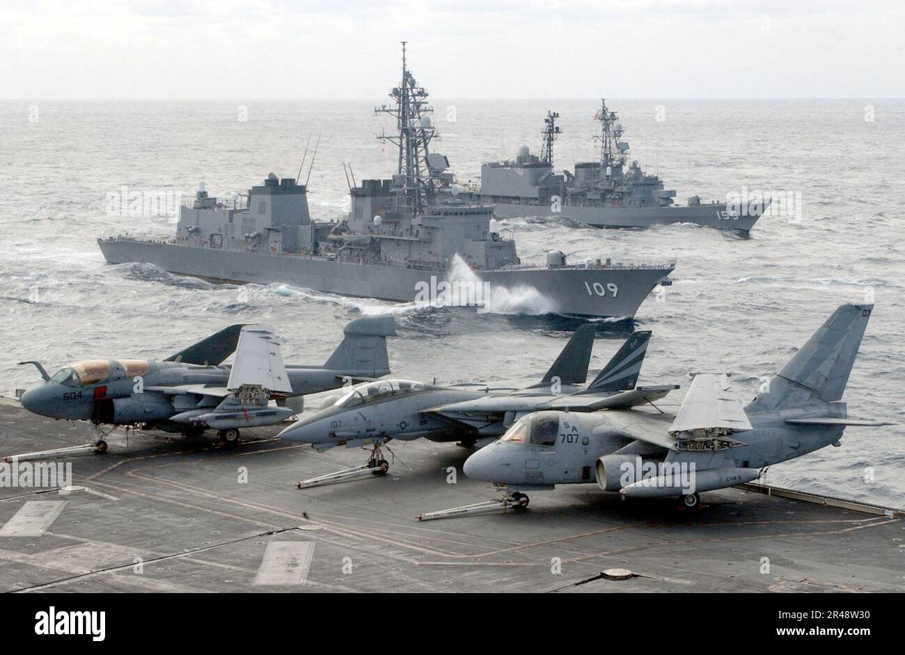 US Navy Two Japanese ships steam alongside Kitty Hawk (CV 63) during multinational exercises ...