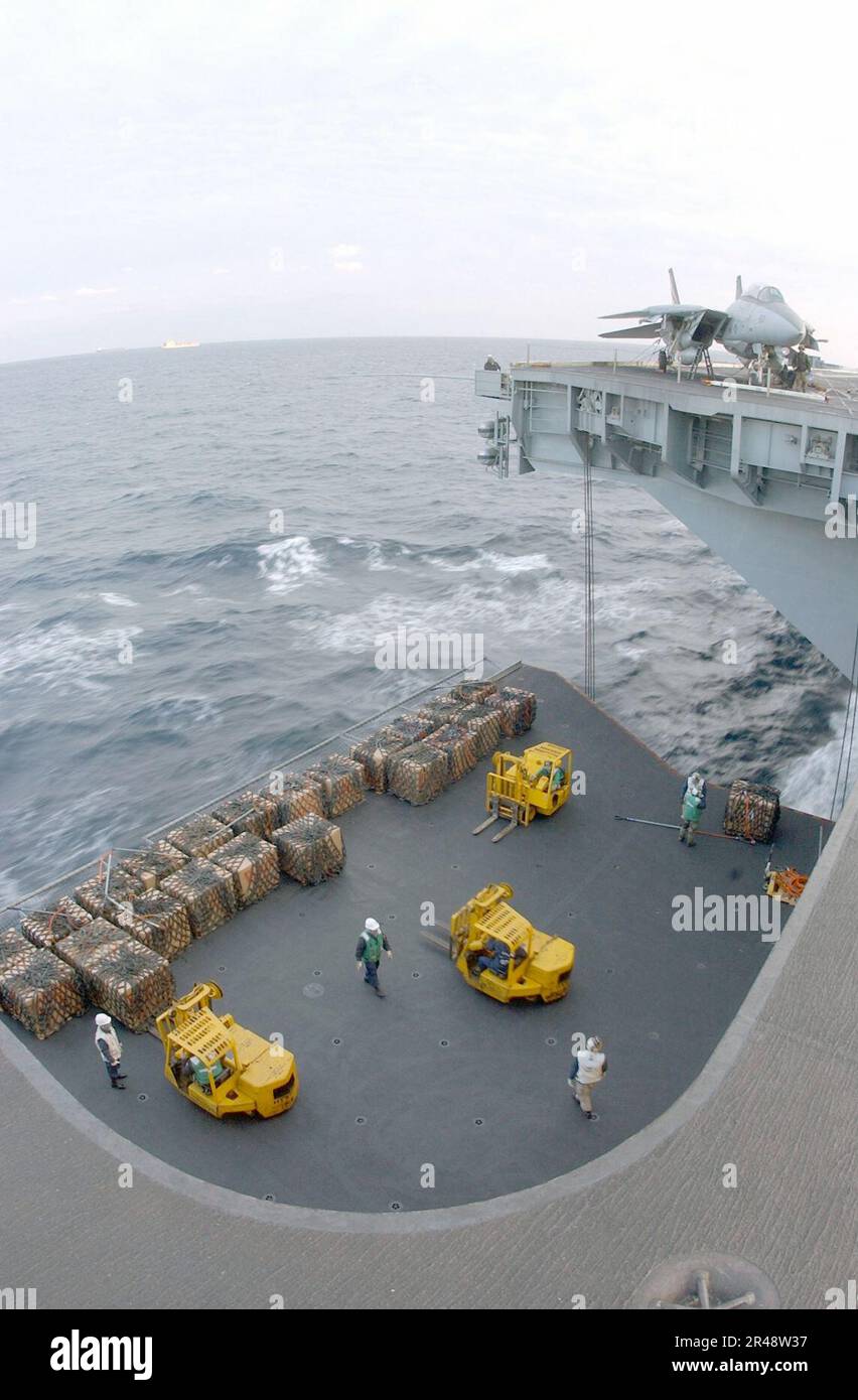 US Navy Supplies are loaded on to one of four aircraft elevators during ...