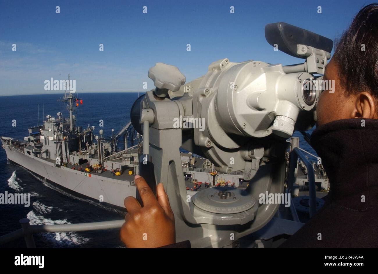 US Navy A sailor looke through the big eyes to observe a signalmen ...