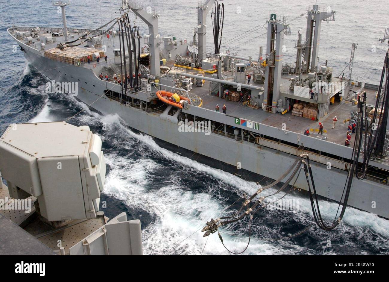 US Navy USNS Rappahannock (T-AO 204) guides over hoses to transfer fuel ...