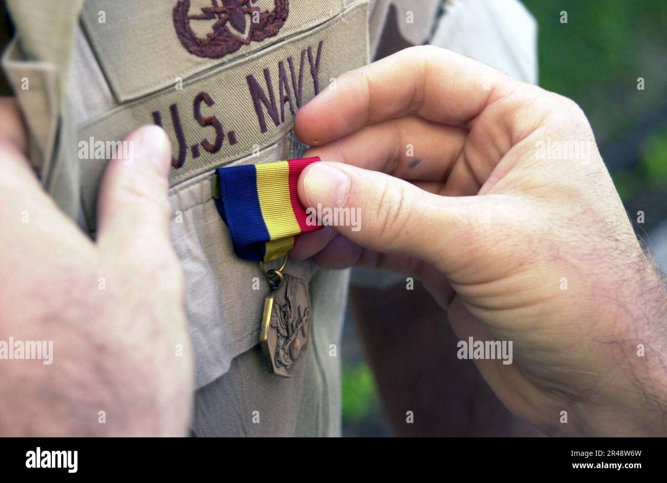 US Navy The Navy and Marine Corps Medal is pinned on the uniform of ...