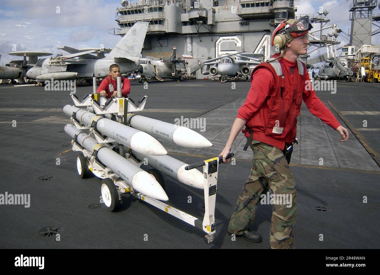 US Navy pulling a skid of (AIM-120) missiles to an F-A-18 Stock Photo ...