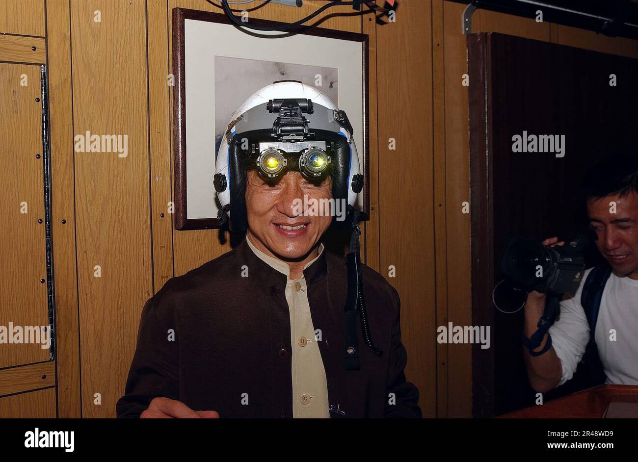 US Navy Jackie Chan tries on a fighter pilot's helmet with night vision ...