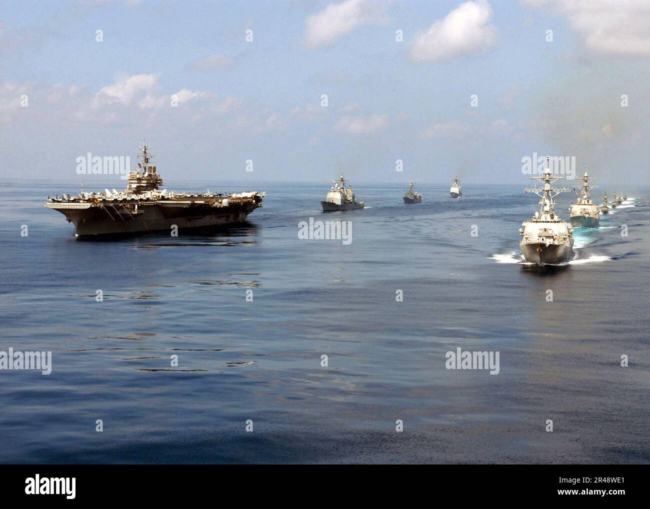 US Navy Constellation steams through the ocean with ships in its Battle ...