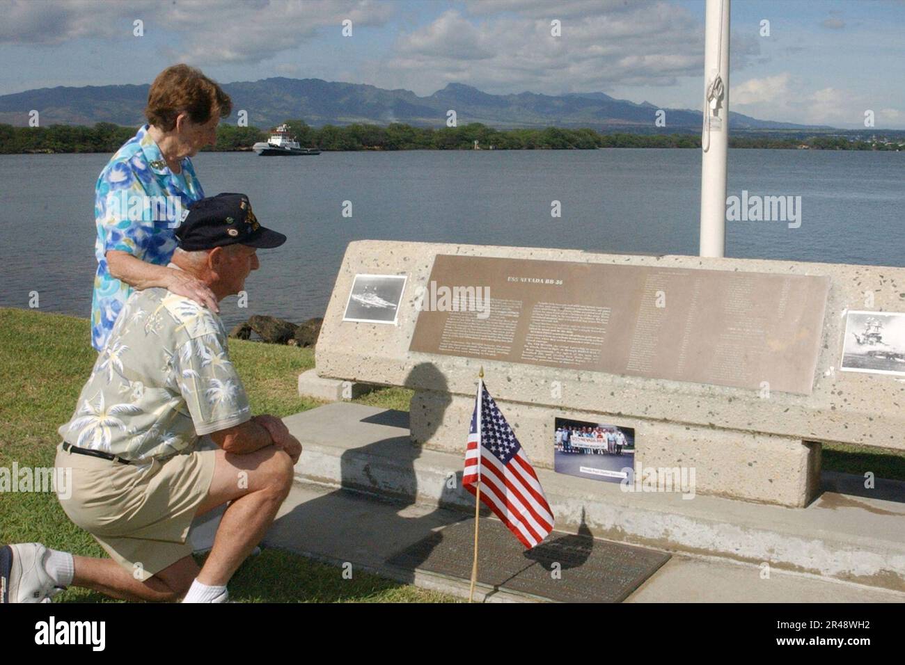 US Navy USS Nevada survivor and his wife look silently at photographs ...