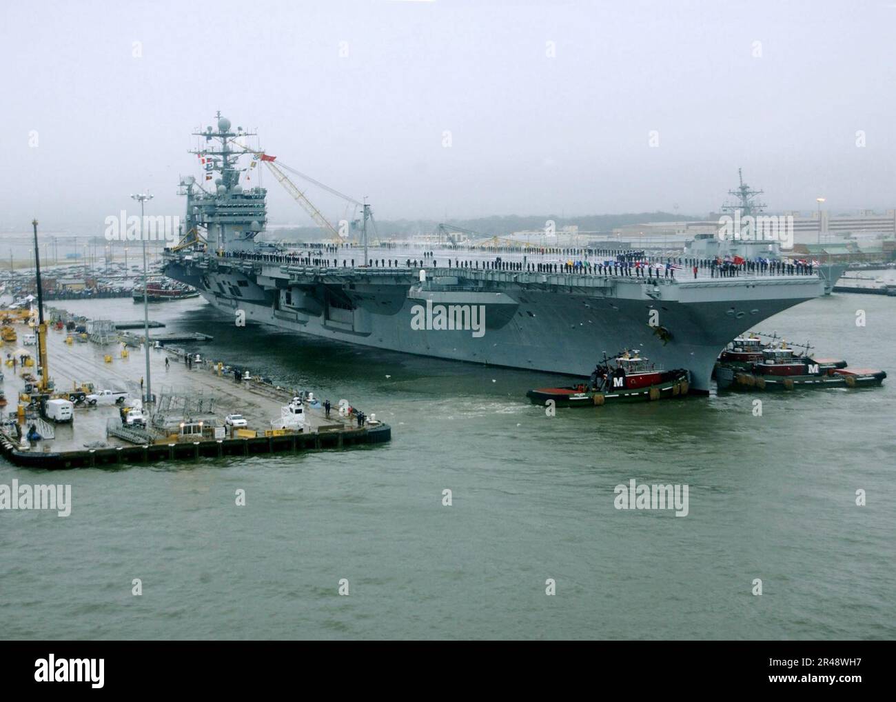 US Navy Sailors man the rails aboard the aircraft carrier USS Harry S ...