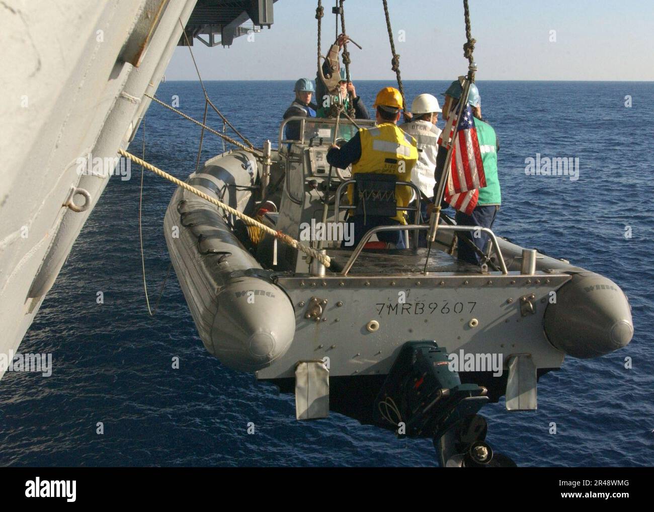 US Navy Sailors hold on to monkey lines as their rigid hull inflatable ...