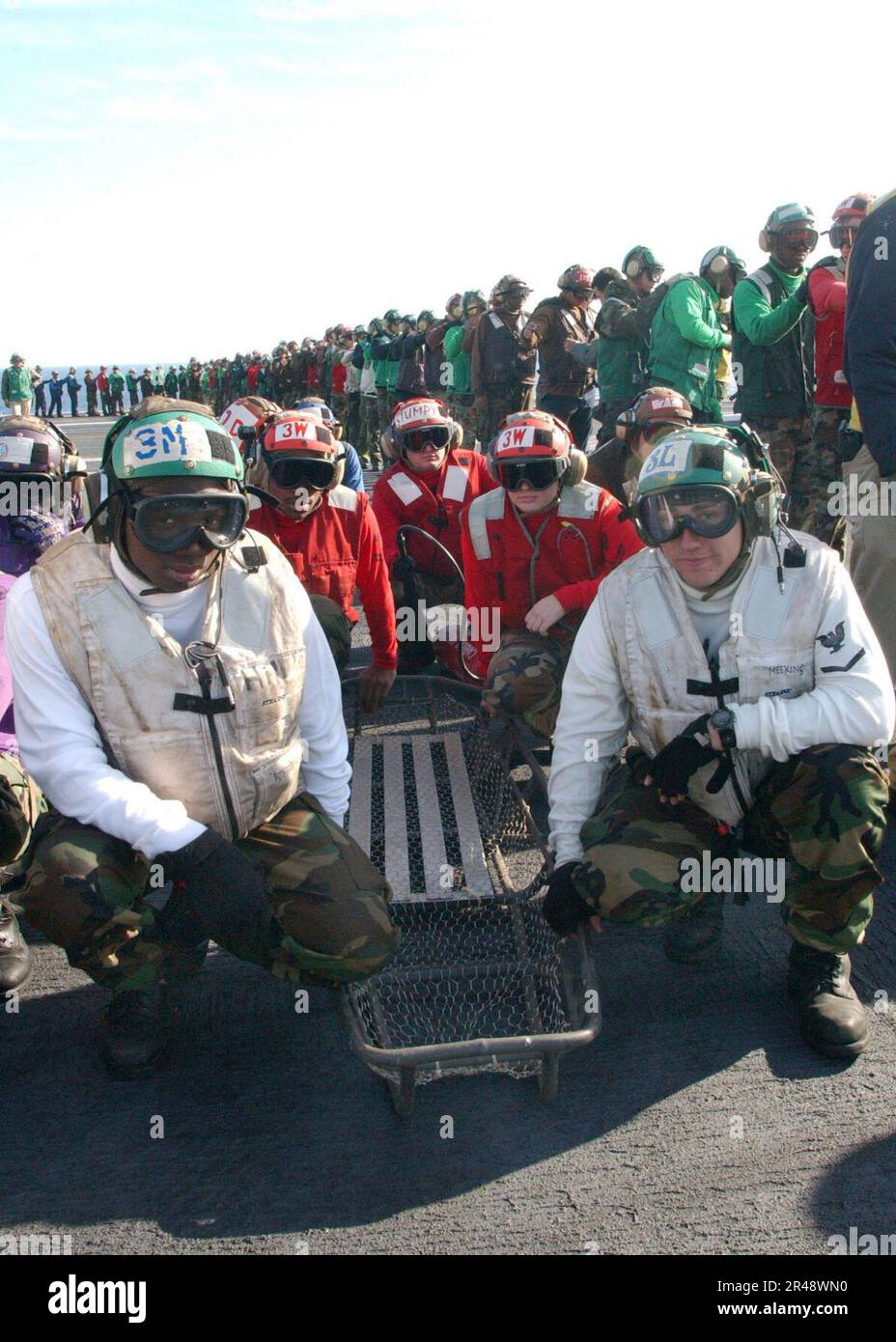 US Navy Flight deck Sailors await orders to assist during a mock crash ...