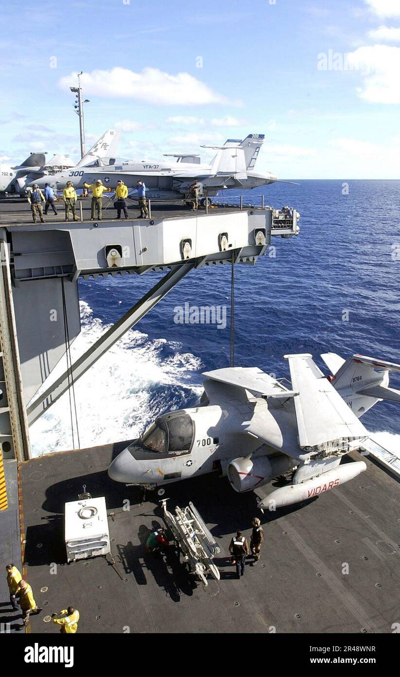 US Navy Flight deck personnel prepare to elevate an S-3 to the ship's ...
