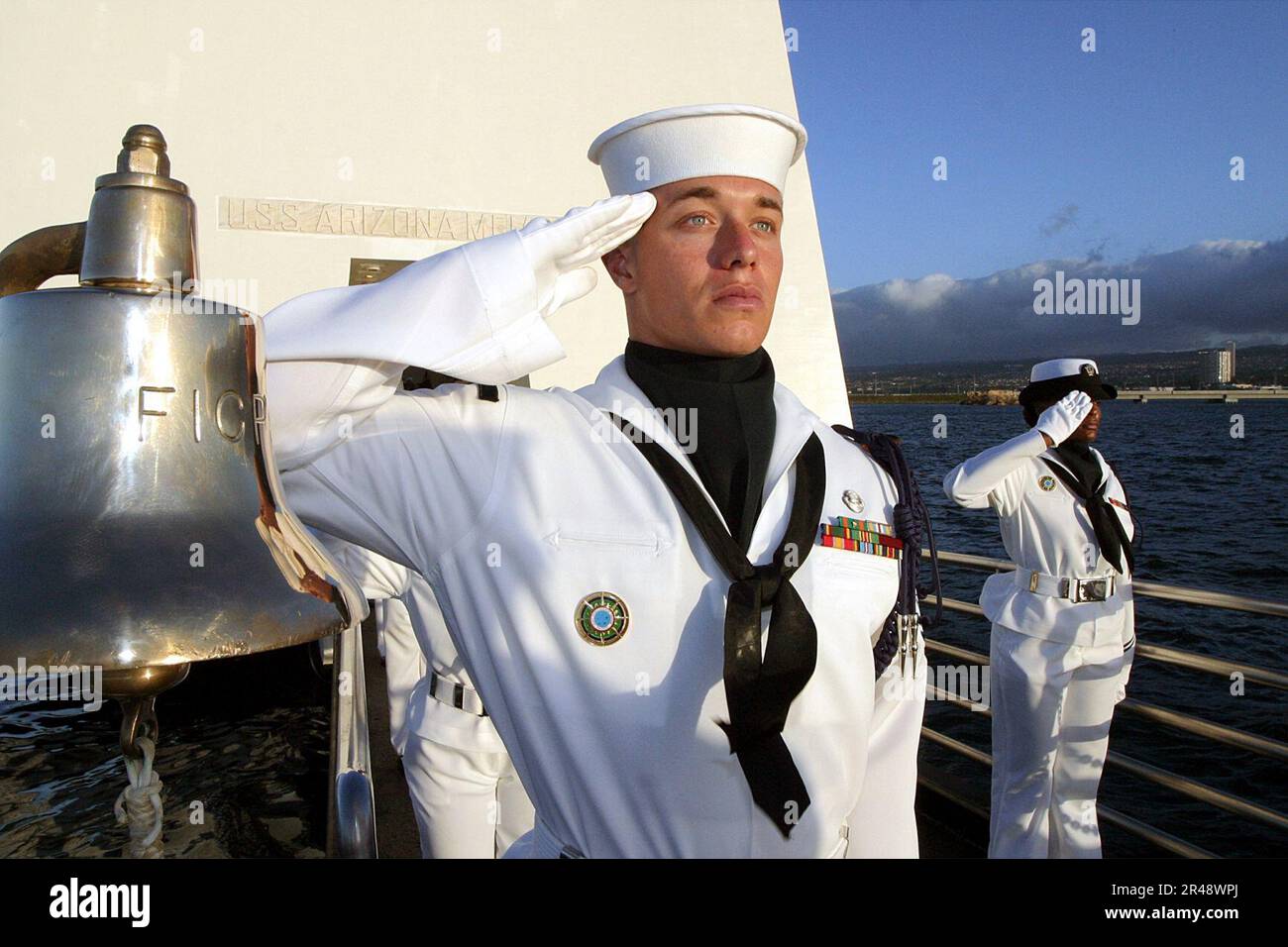 US Navy saluting the official party at the USS Arizona Memorial Stock ...