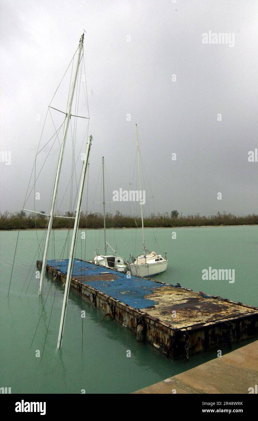 US Navy Pleasure craft sit heavily damaged or sunk by high surf and ...