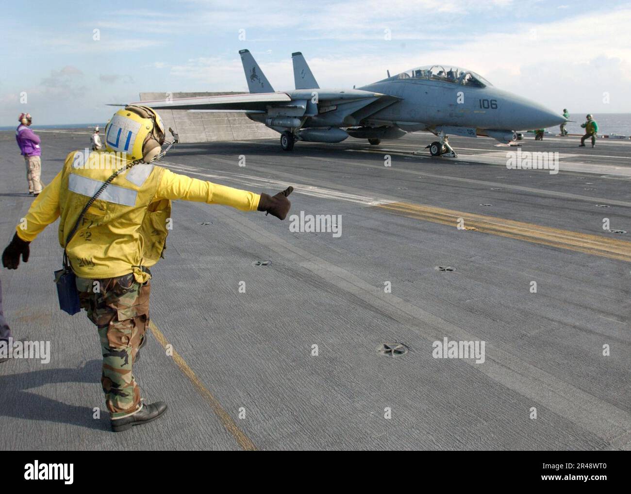 US Navy plane director positions an F-14 Stock Photo - Alamy
