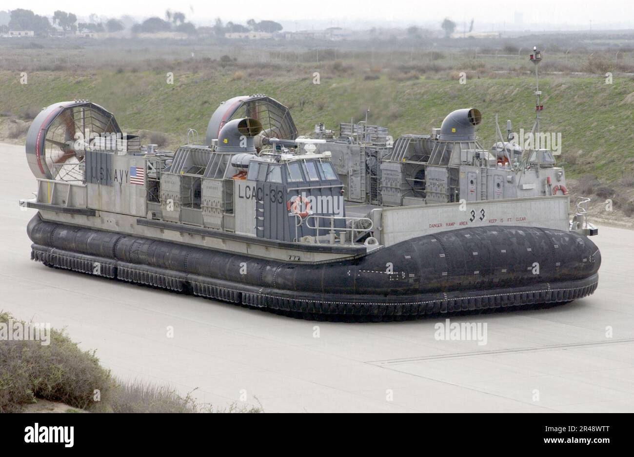 US Navy LCAC maneuvers down the ramp to the Pacific Ocean during ...