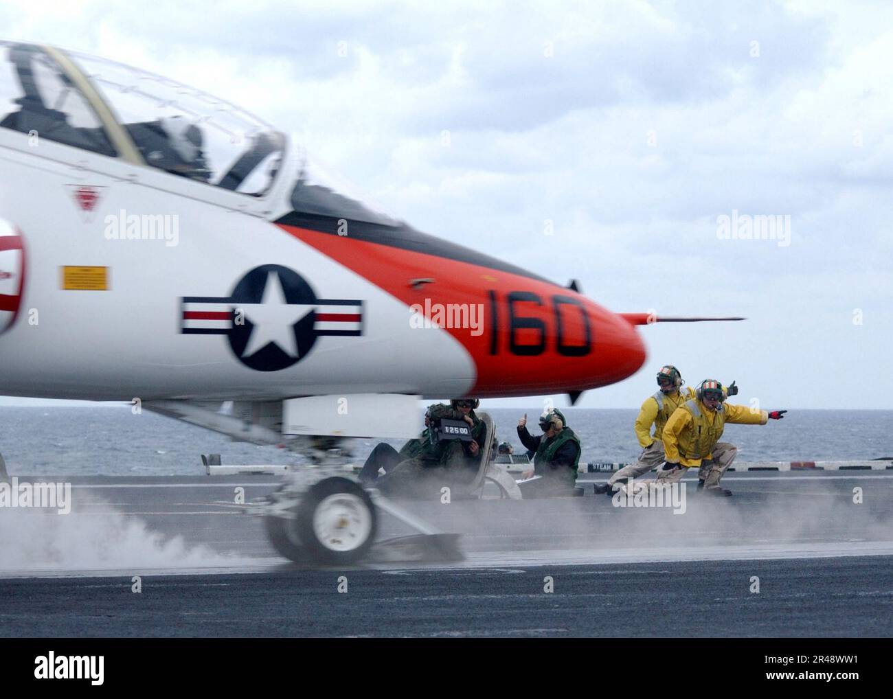 US Navy Two Flight Deck Catapult Officers signal to launch a T-45C ...