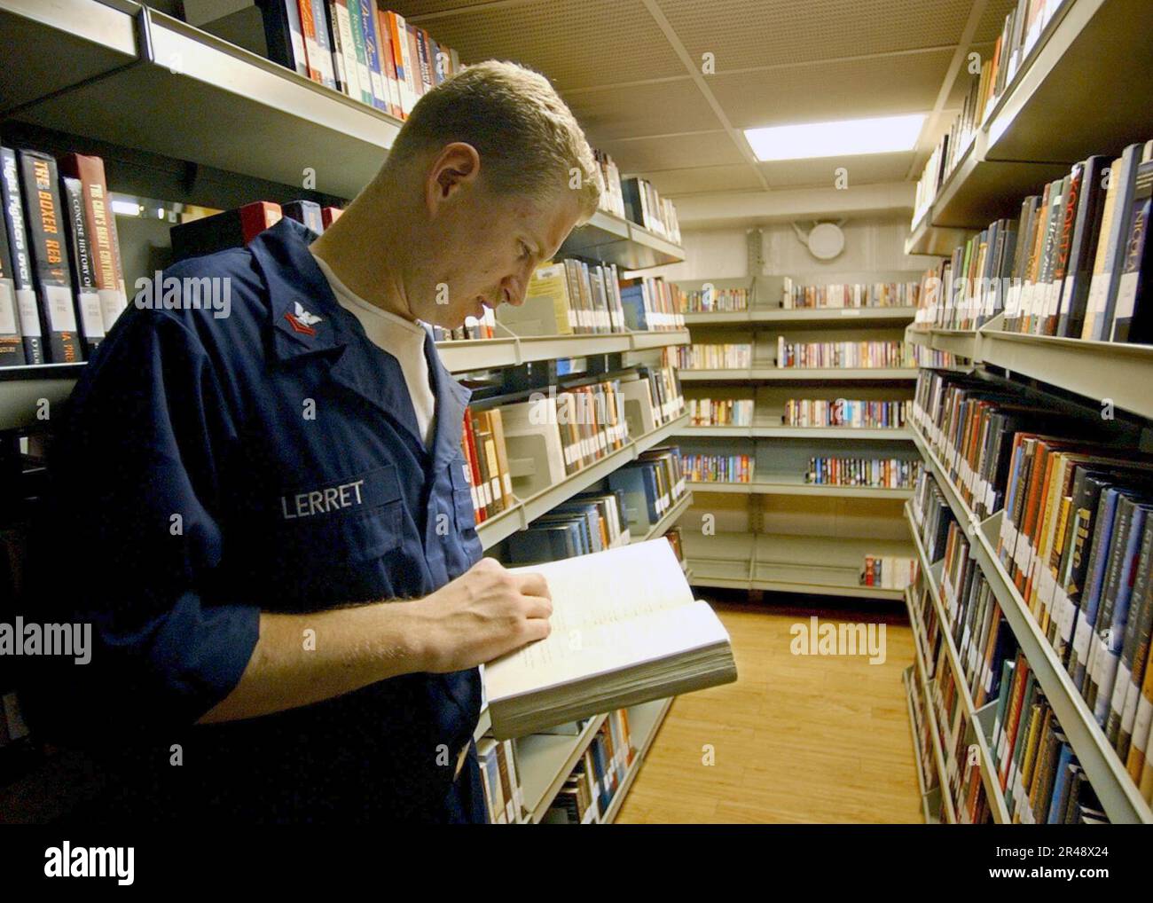 US Navy reading a book in the Truman's library Stock Photo - Alamy