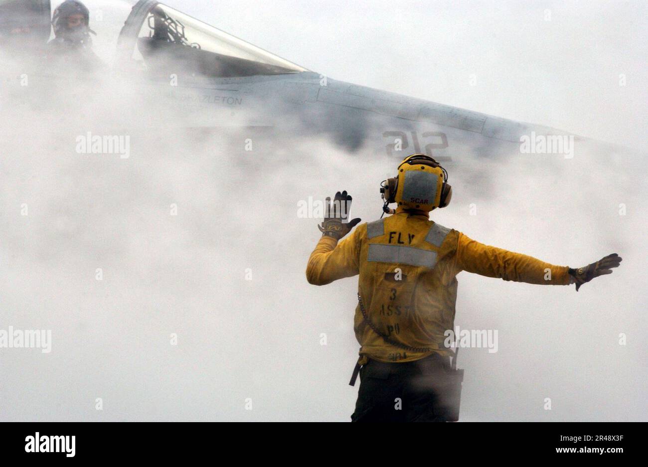US Navy A flight deck director guides an F-A-18 Hornet from the Hunters ...