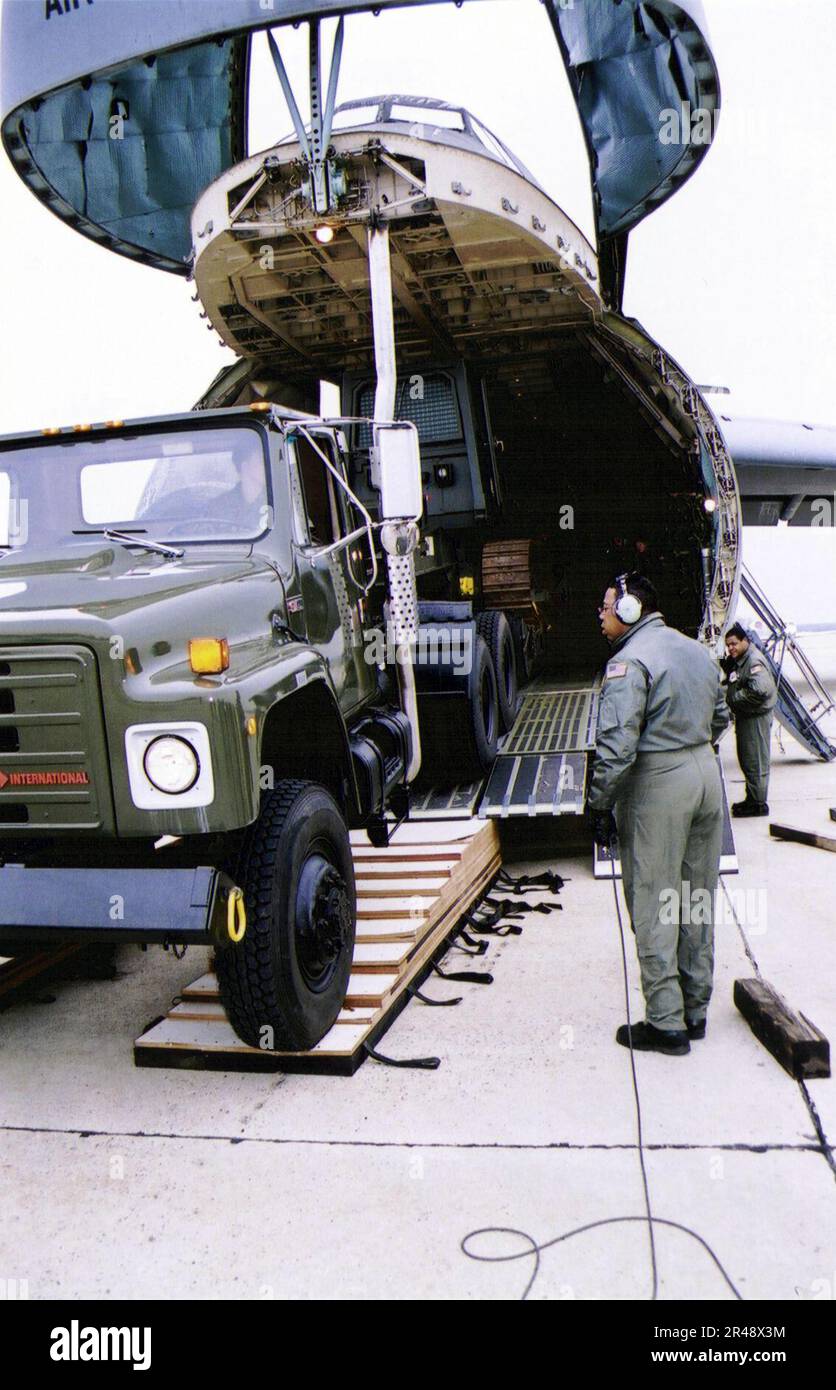 US Navy Seabees back a 25-ton tractor-trailer onto a U.S. Air Force C-5 ...