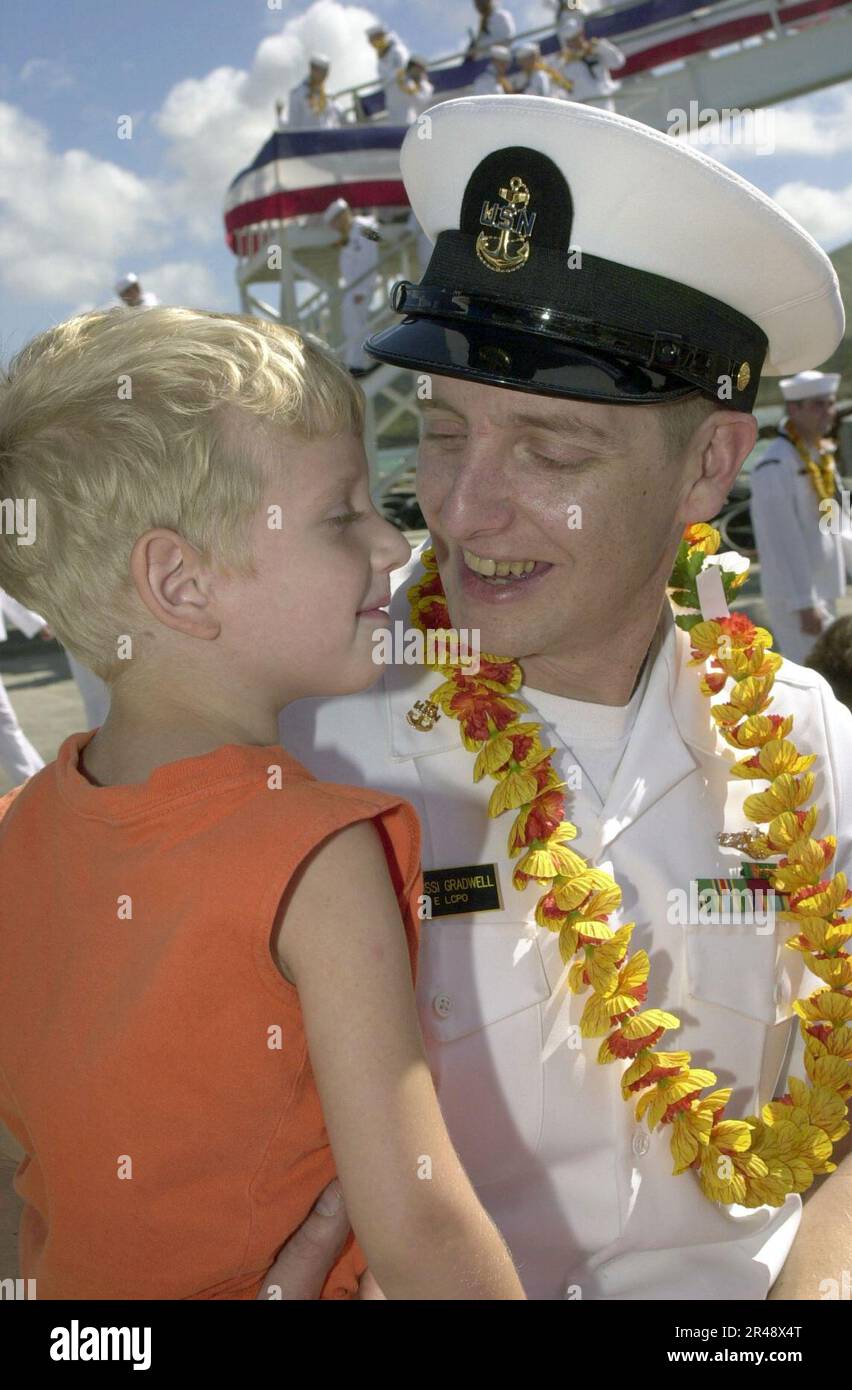 US Navy Sailor greets his family after the fast attack sub USS San ...