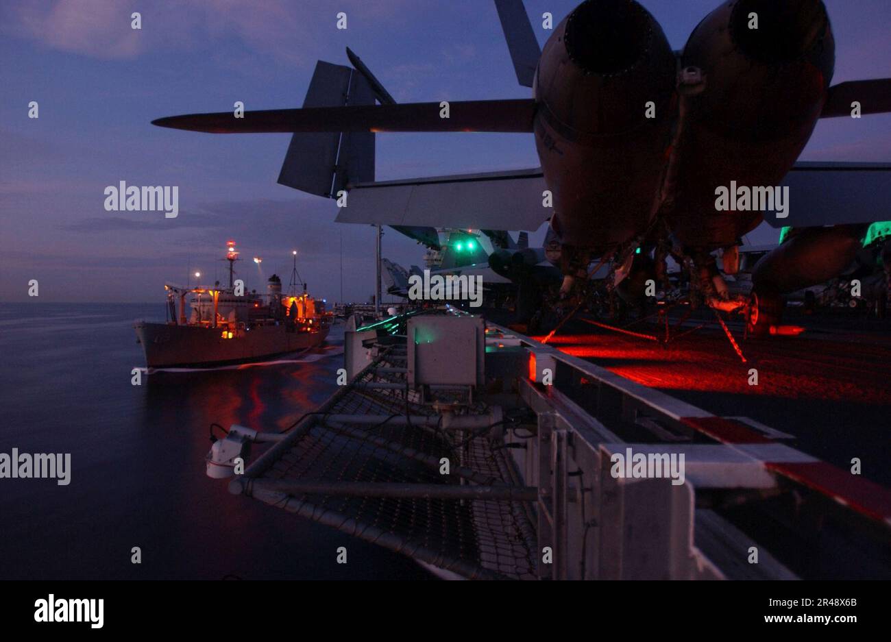US Navy Truman moves along side USNS Spica during an early morning ...