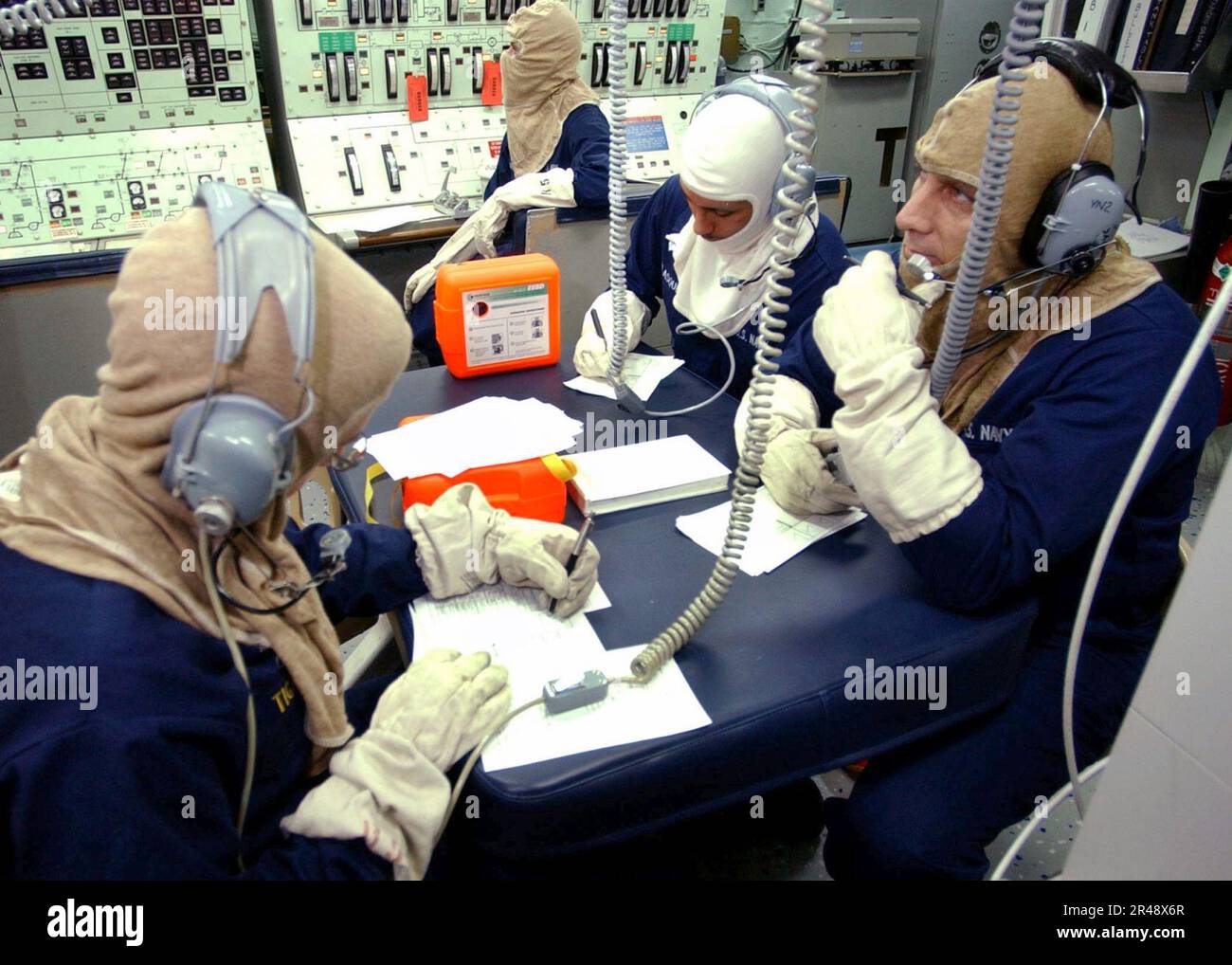 US Navy Ship's phone talkers in the Combat Control Center receive ...
