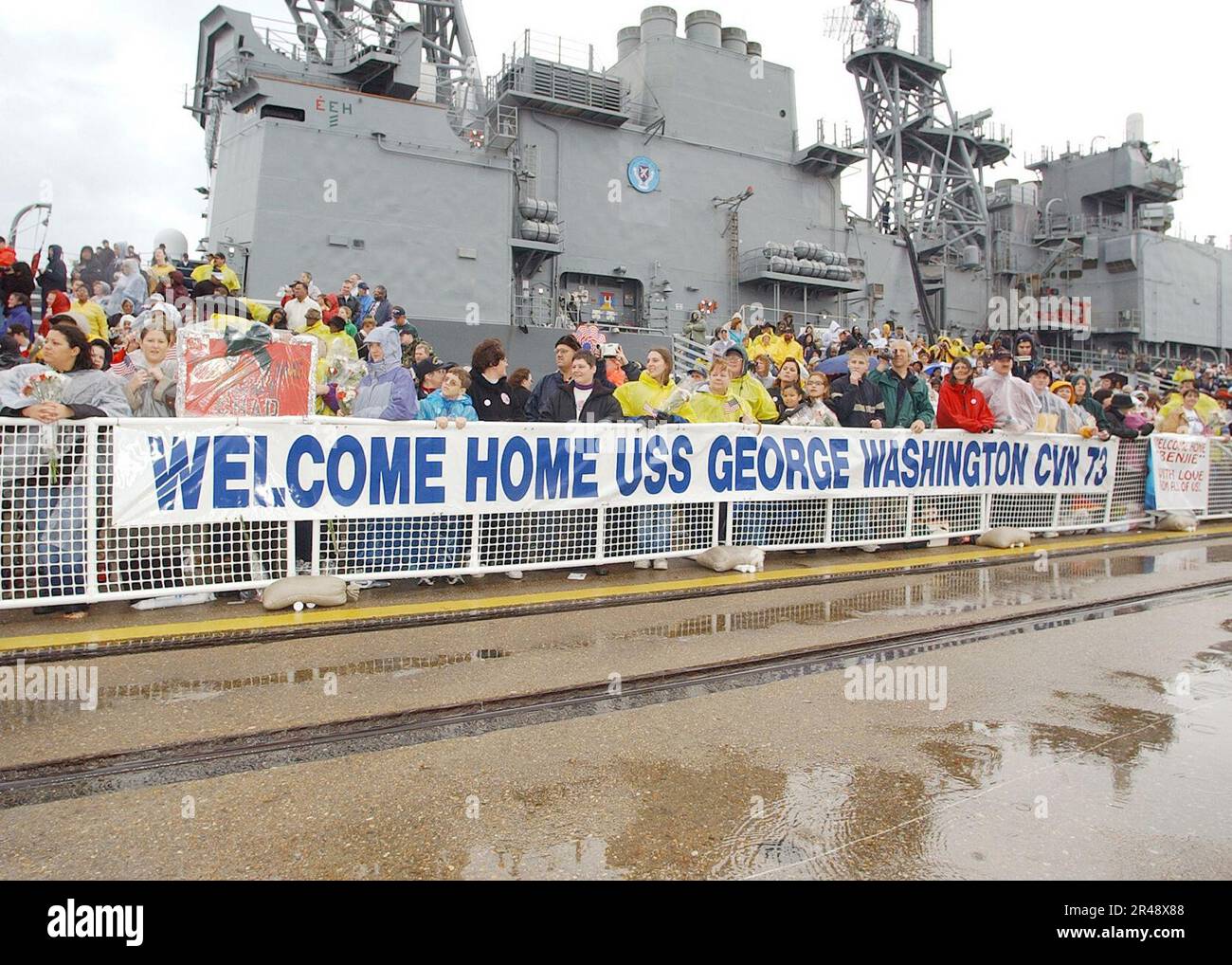 US Navy Family members and friends anxiously await the arrival of USS ...