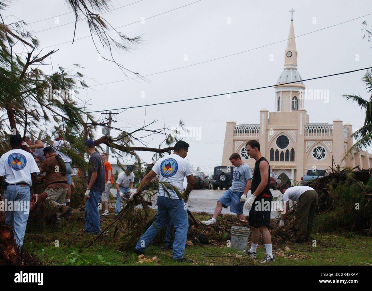 US Navy volunteers assist the local residents of Inarjan, Guam Stock ...