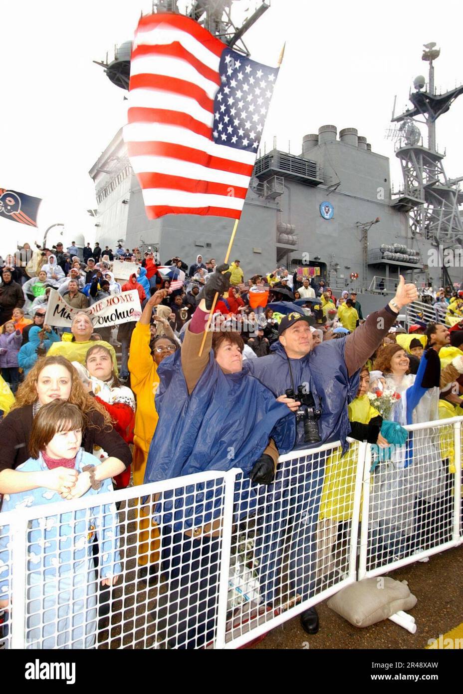 US Navy Family members and friends cheer on as they watch the arrival ...