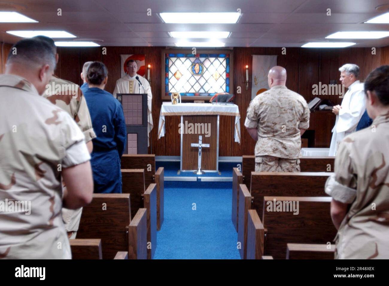US Navy A U.S. Navy Chaplain conducts religious services aboard ship ...