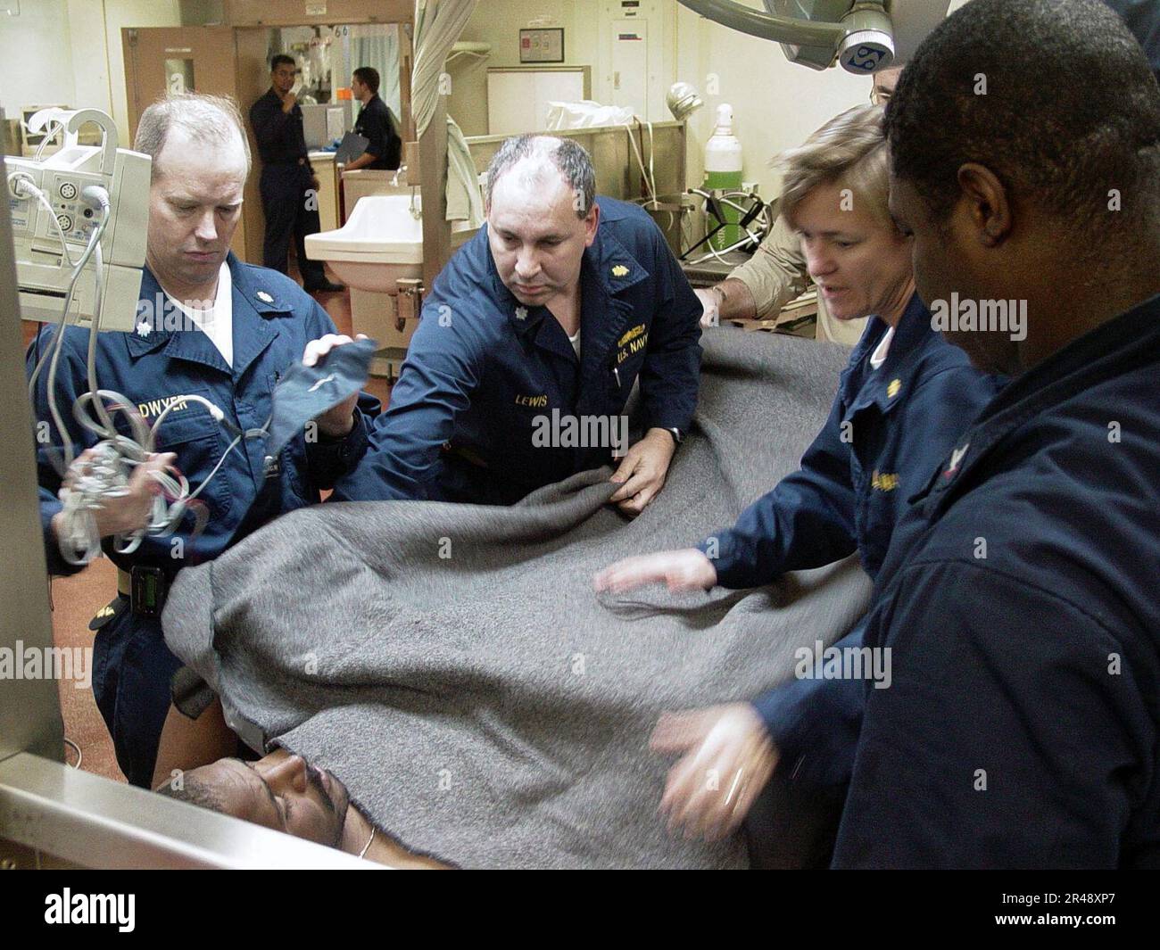 US Navy U.S. Navy nurse Cmdr. Brian Lewis covers a rescued fisherman ...